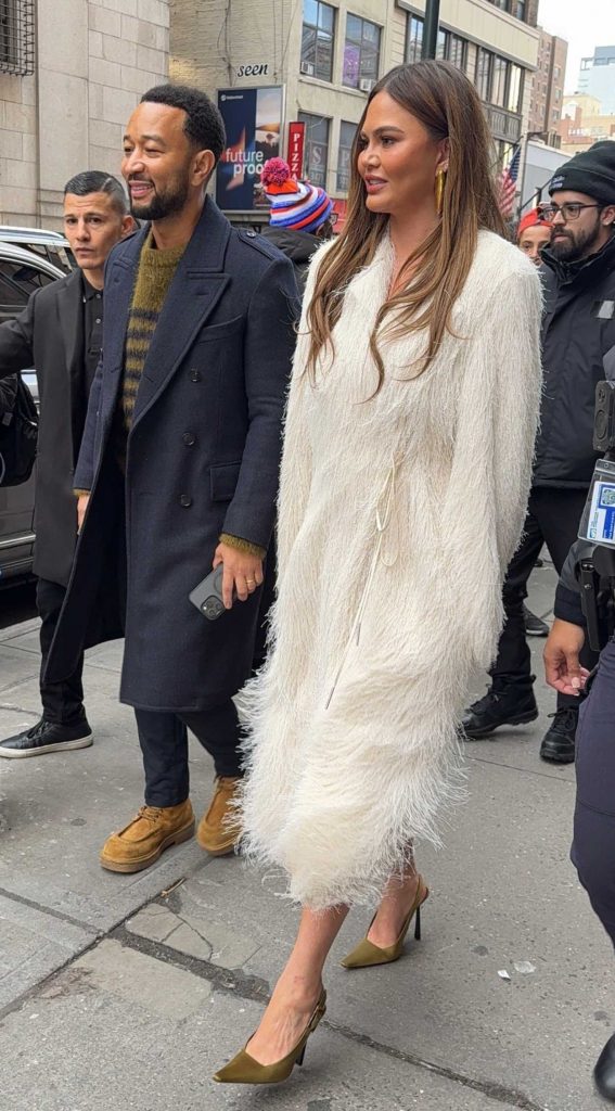 Chrissy Teigen in a White Fur Coat Leaves the Knicks Game in New York ...